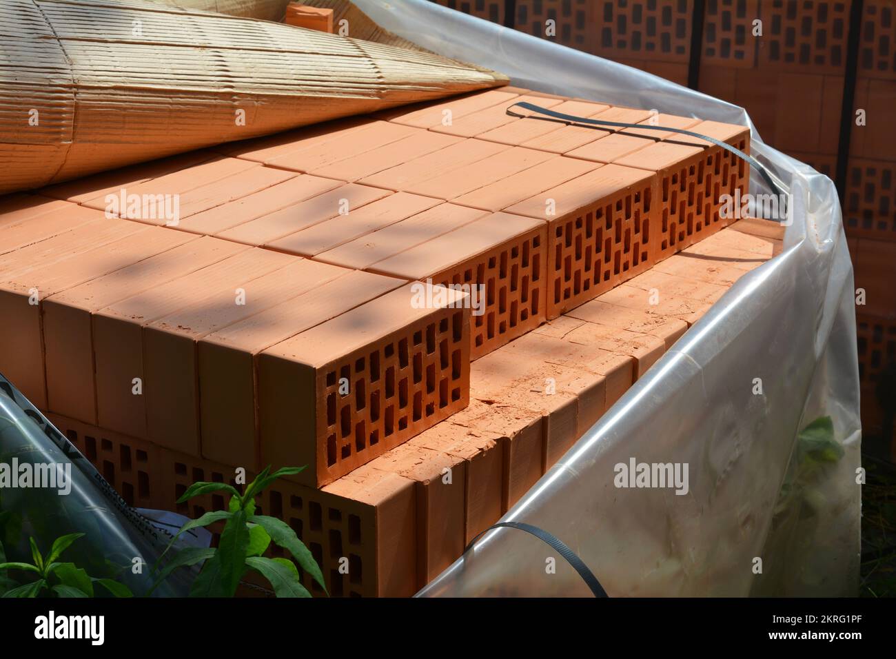 Stacks of packed in waterproof film bricks outdoor. Large brick stack ...