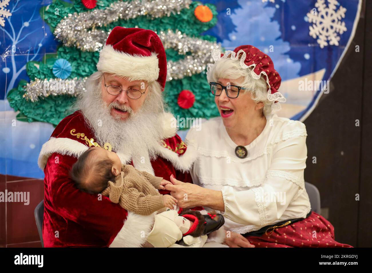 A young boy sits on Santa’s lap during Operation Santa Claus in Scammon ...