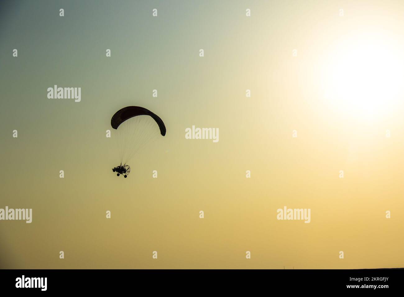 motor gliding in during sunset background with silhouette in a desert ...
