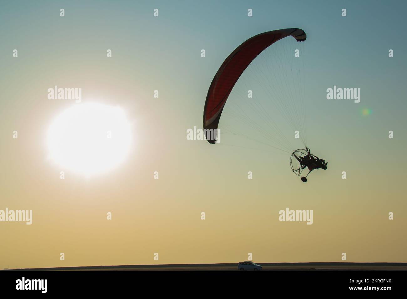 motor gliding in during sunset background with silhouette in a desert ...