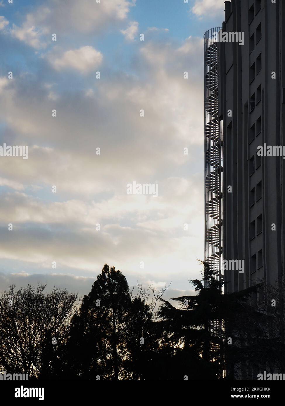 Spiral fire escapes of a tall building. High apartment building with ...