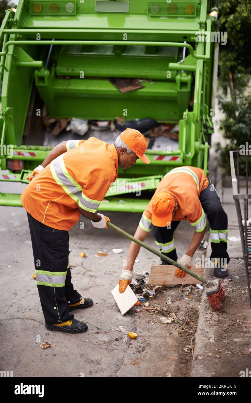 Garbage collection day. a garbage collection team at work Stock Photo ...