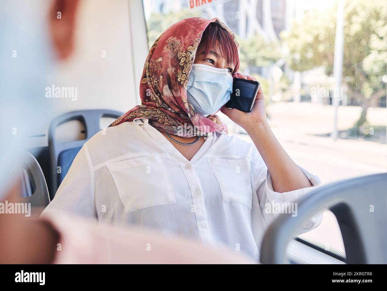 Muslim, phone and bus woman in covid face mask talking of travel safety ...