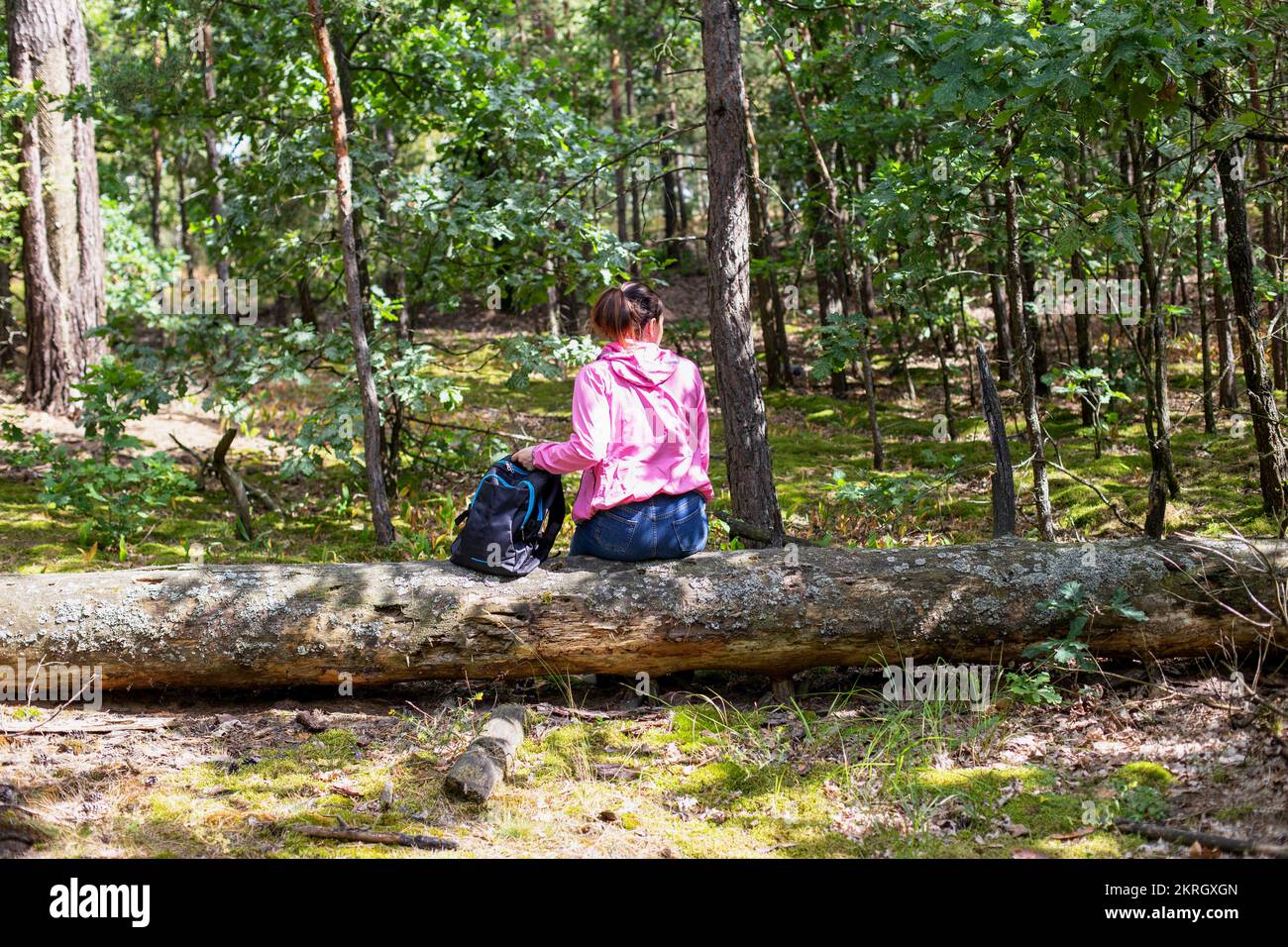 A mushroom picker girl with a backpack got lost in the forest. The girl ...