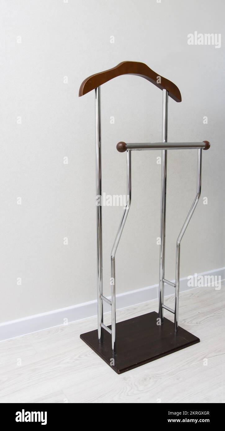 Modern floor standing suit rack against a white wall, indoors Stock ...