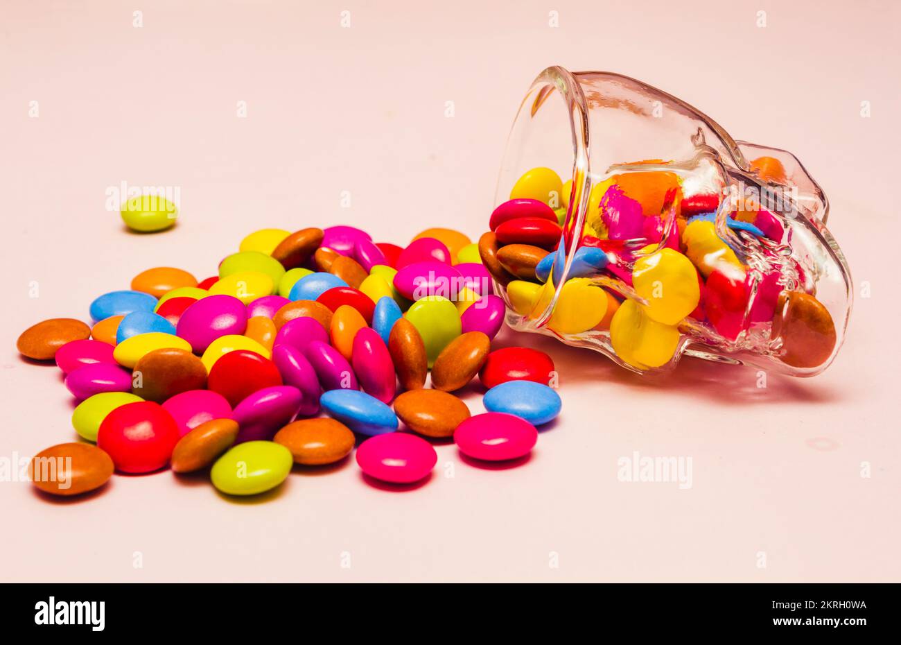 Trick or treats spilled lolly jar with a pile of colorful Halloween ...