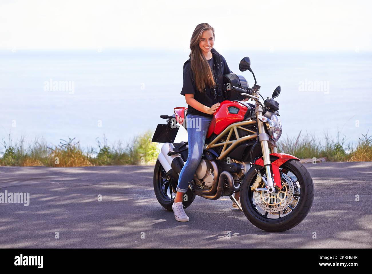 She was born to ride. A young woman sitting on her motorcycle Stock ...