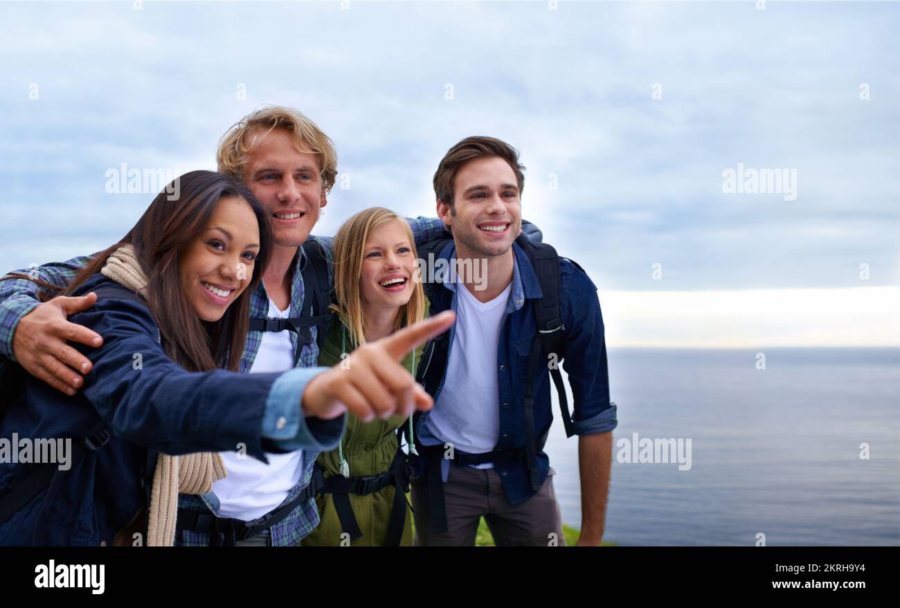 Wow Look at that. Four young people admiring the view together Stock ...