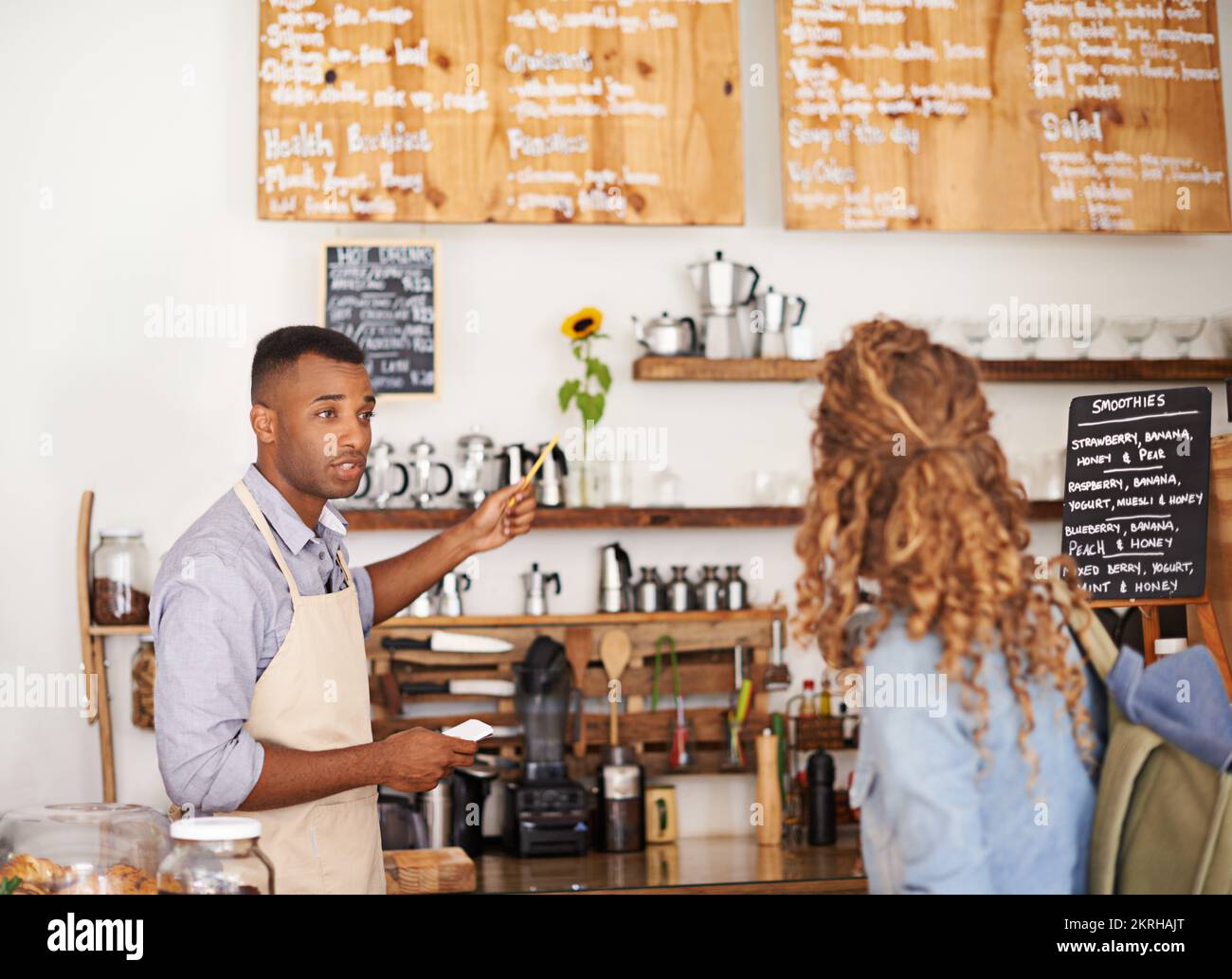 Have you tried our new blend of coffee. young barista taking a ...