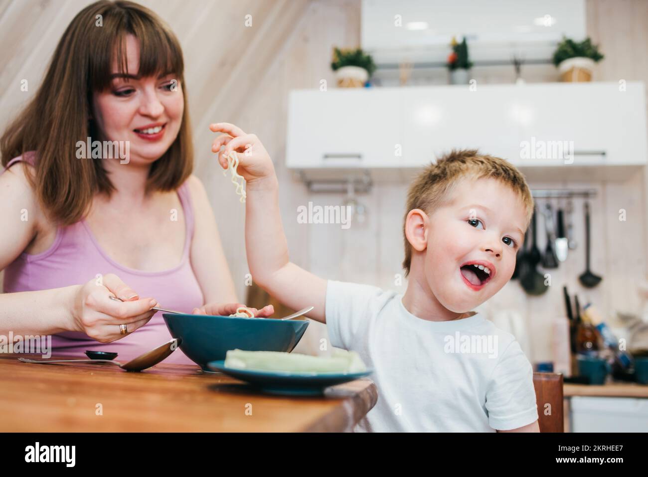 Cheerful little child refuses to eat pasta Stock Photo - Alamy