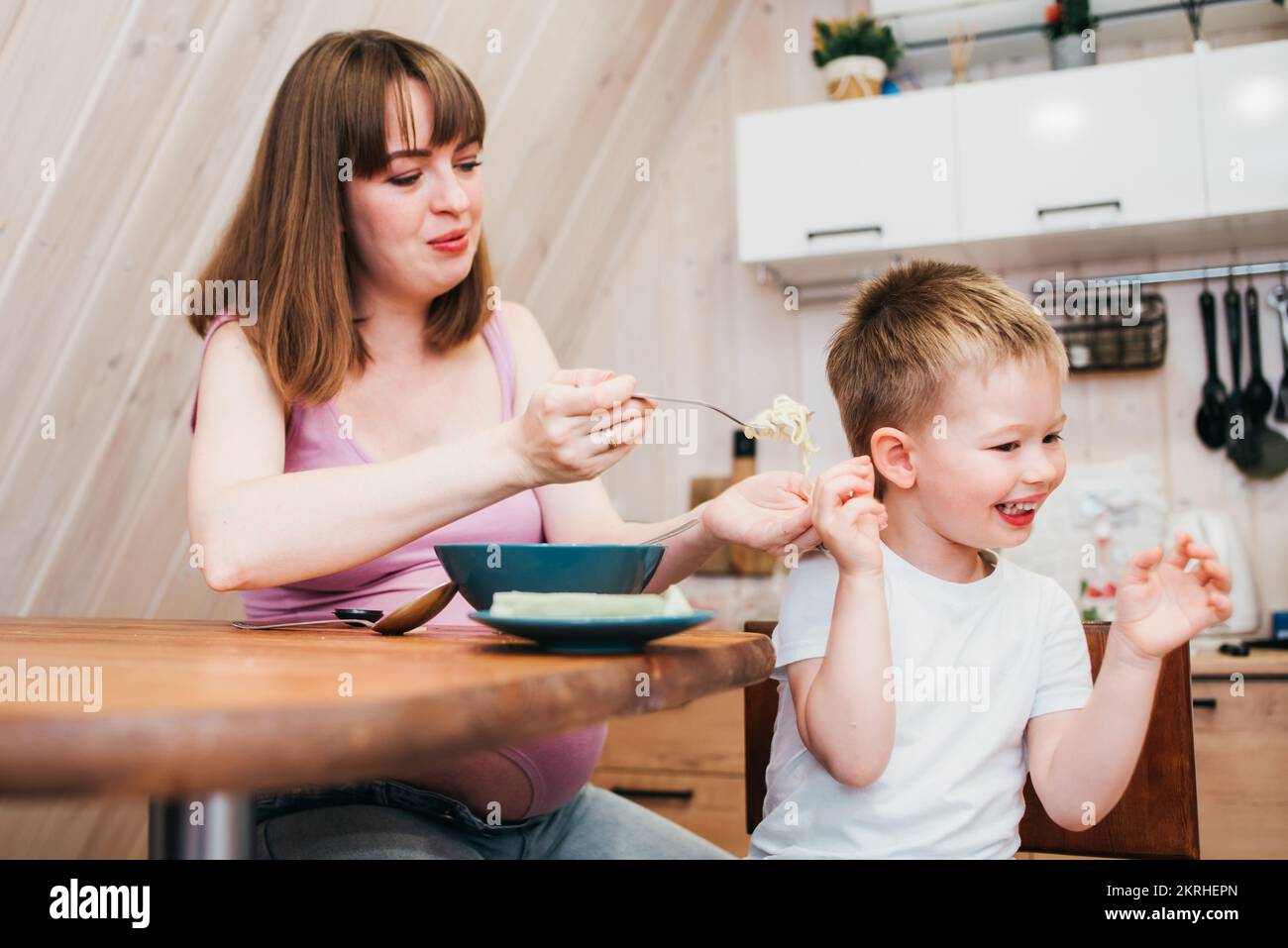 Cheerful little child refuses to eat pasta Stock Photo - Alamy