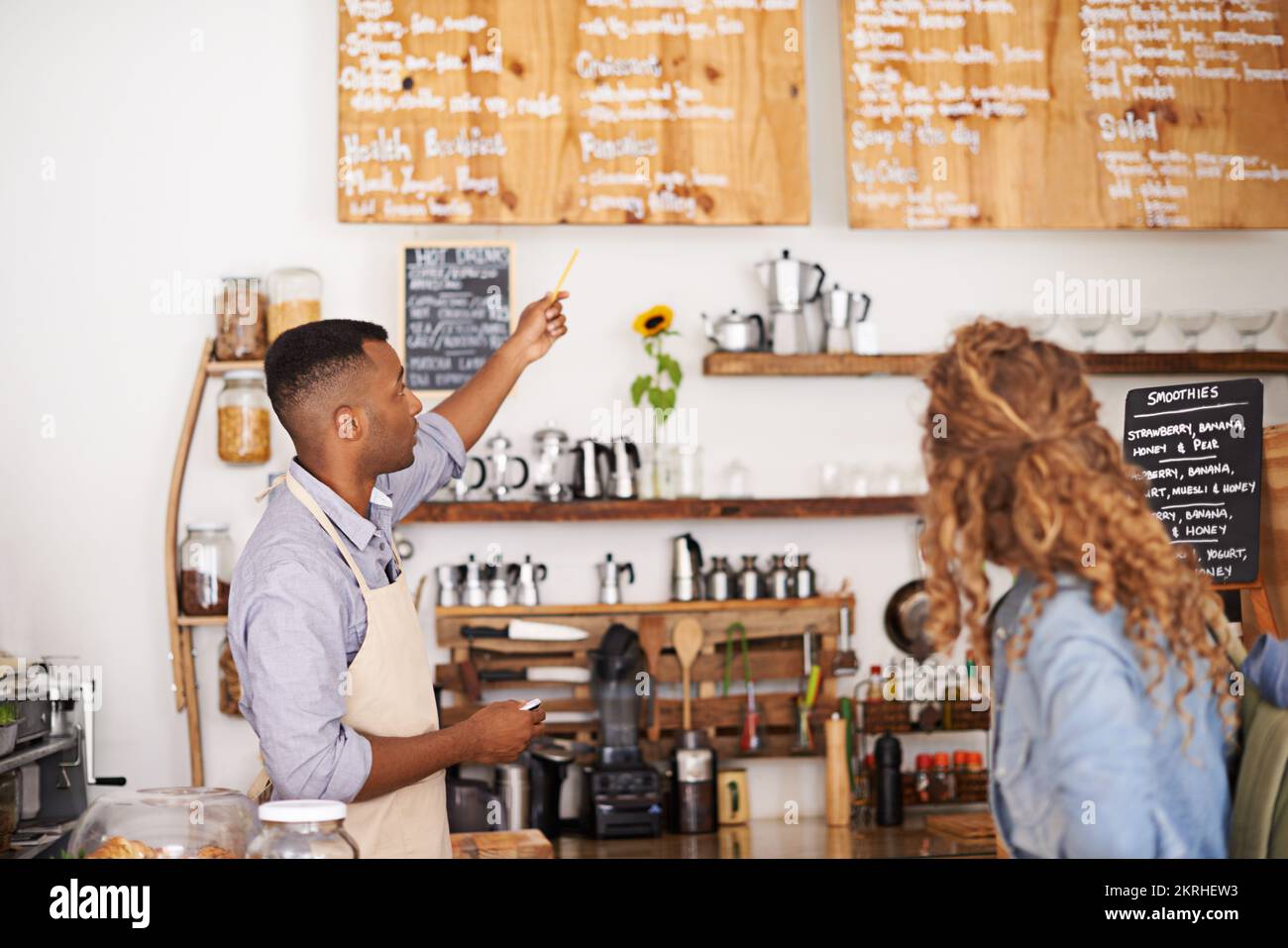 We have some amazing specials today. young barista taking a customers ...