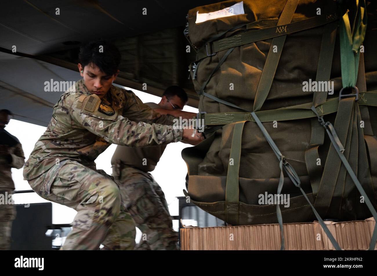 U.S. Soldiers from the 824th Quartermaster Company guide a pallet of ...