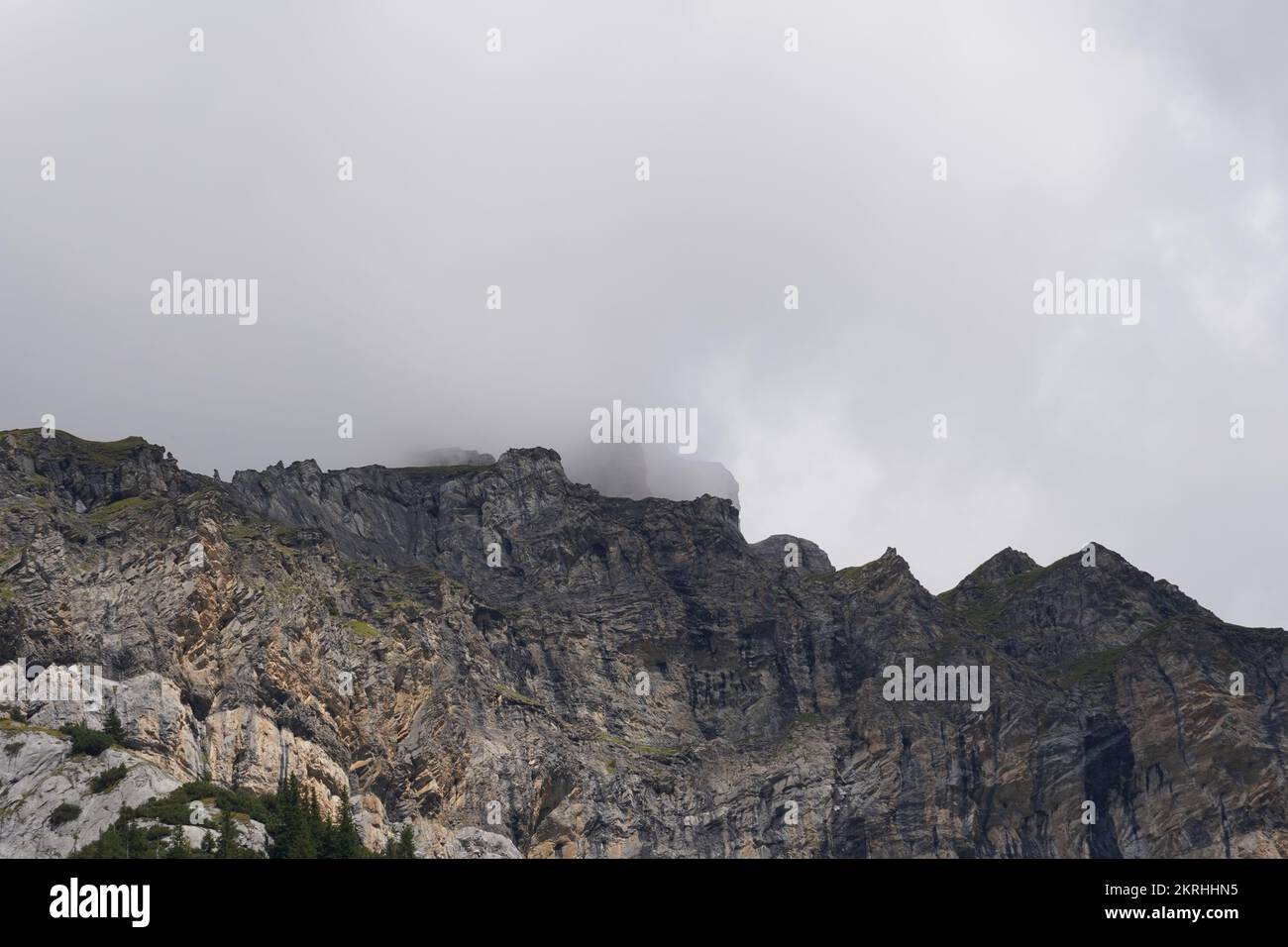 Rocky walls of mountains in low angle view in Switzerland Stock Photo ...