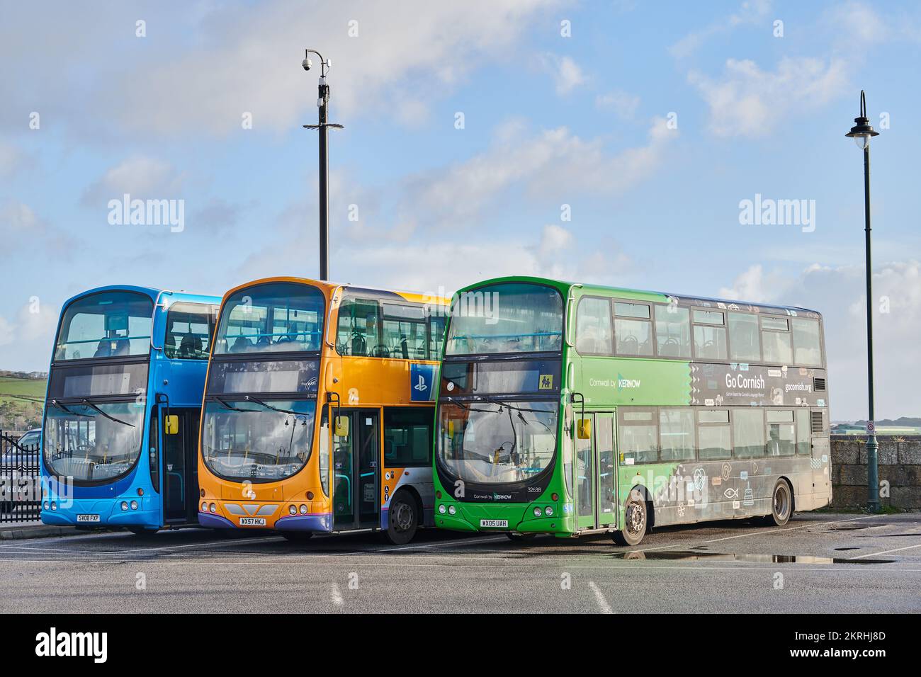 Three double decker buses lined up on the forecourt at the bus station ...