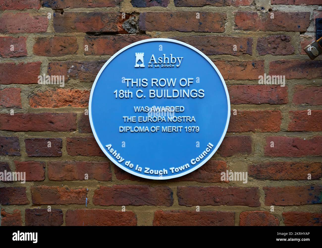 Commemorative blue circle plaque on a brick wall in Ashby de la Zouch ...