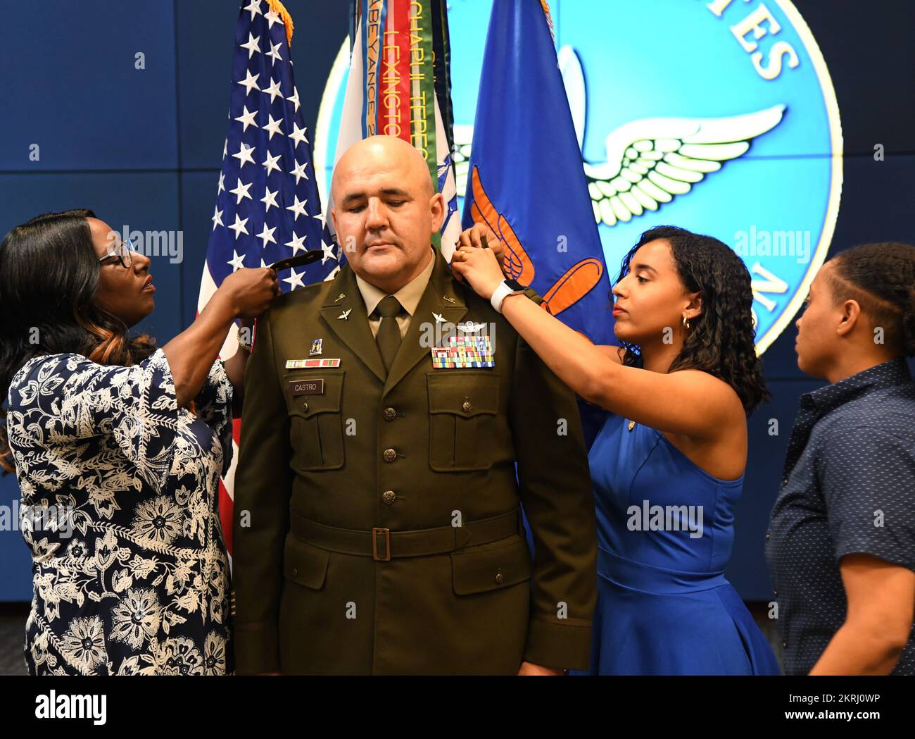 Family members assist with a pinning ceremony as Chief Warrant Officer ...