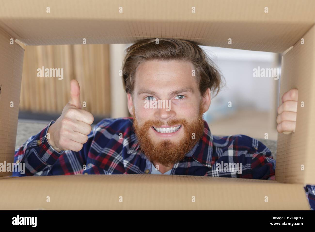 man with thumbs up seen through a cardboard box Stock Photo - Alamy