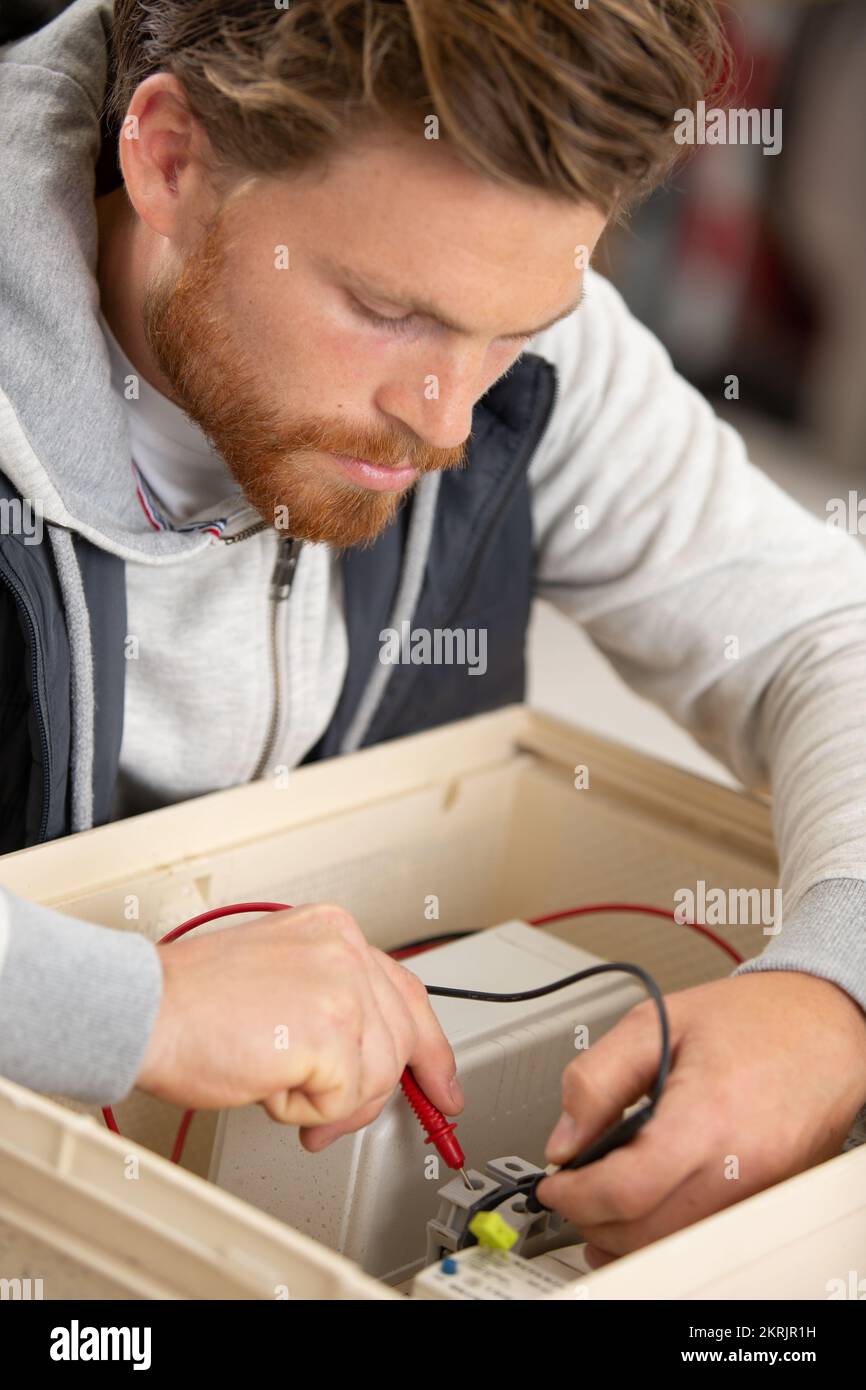 electrician wiring cables in an electrical box Stock Photo - Alamy