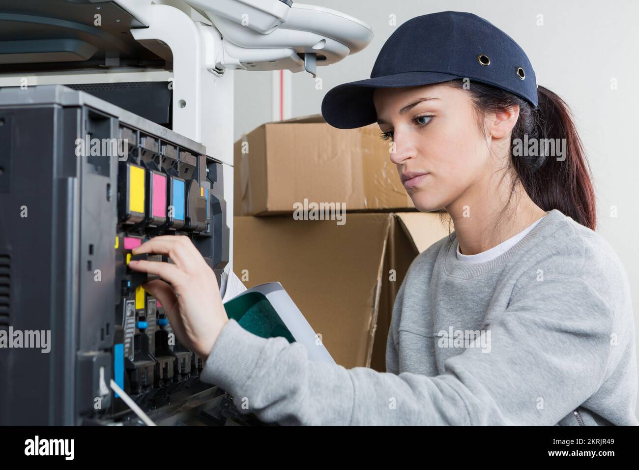 young female technician fixing a printer Stock Photo - Alamy