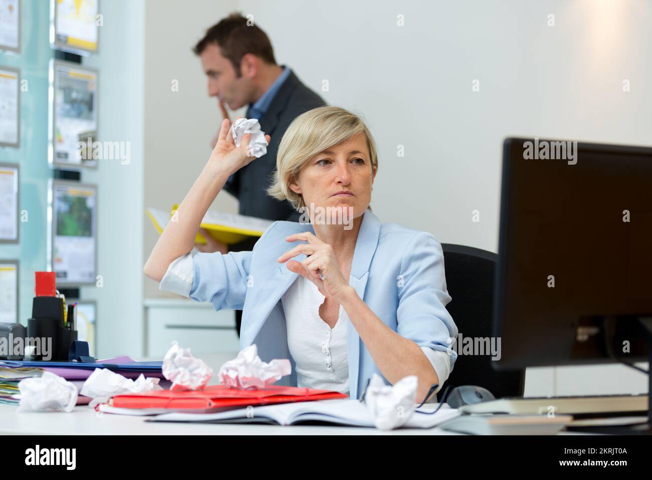 woman throwing crumpled paper balls at computer Stock Photo - Alamy