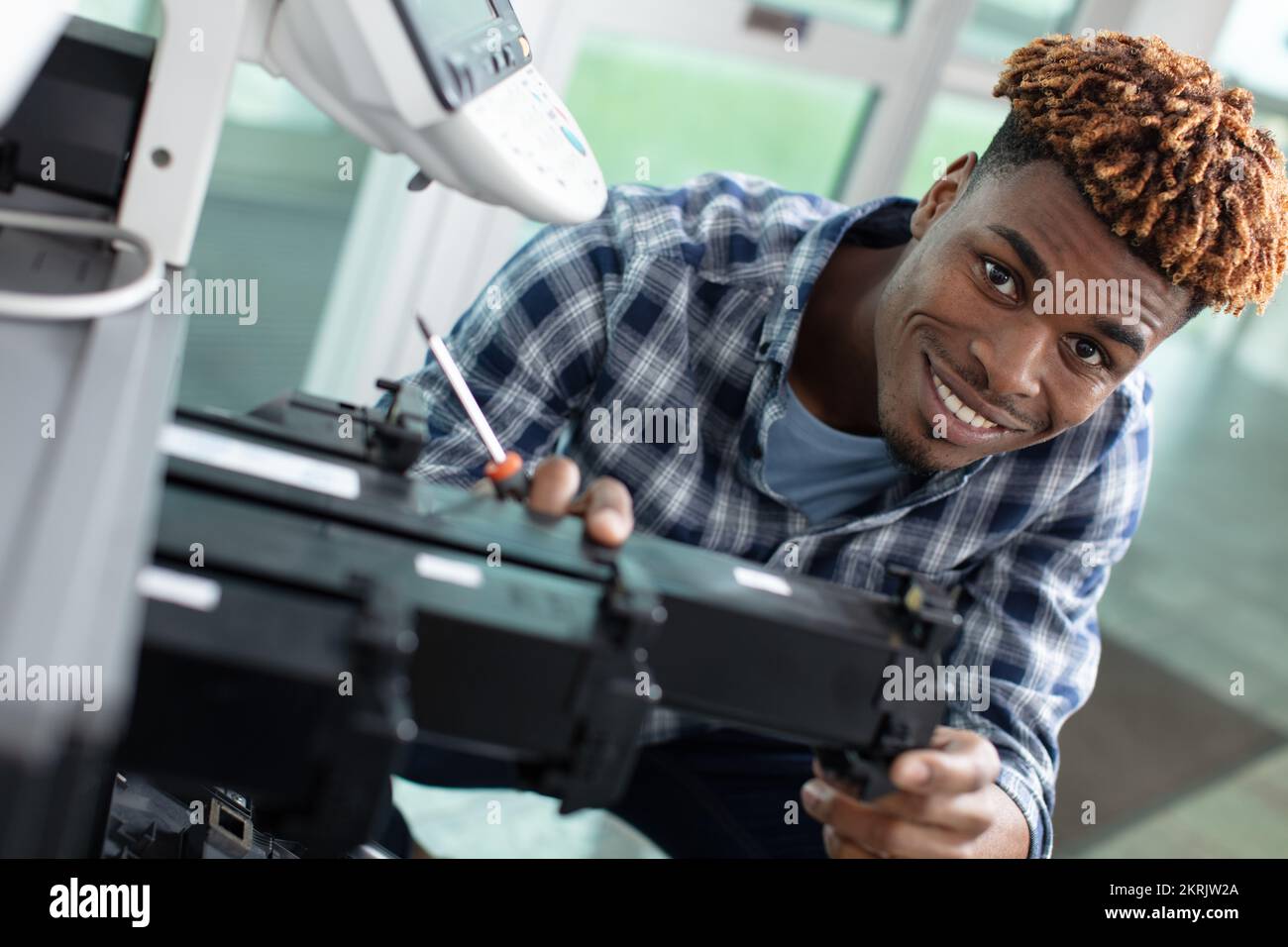 happy male technician fixing a printer Stock Photo - Alamy