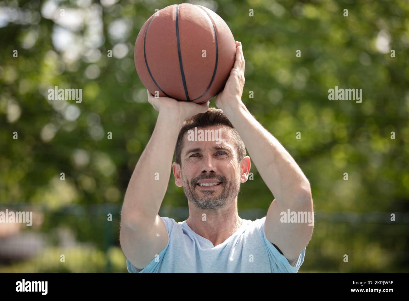 Young man bouncing basketball hi-res stock photography and images - Alamy