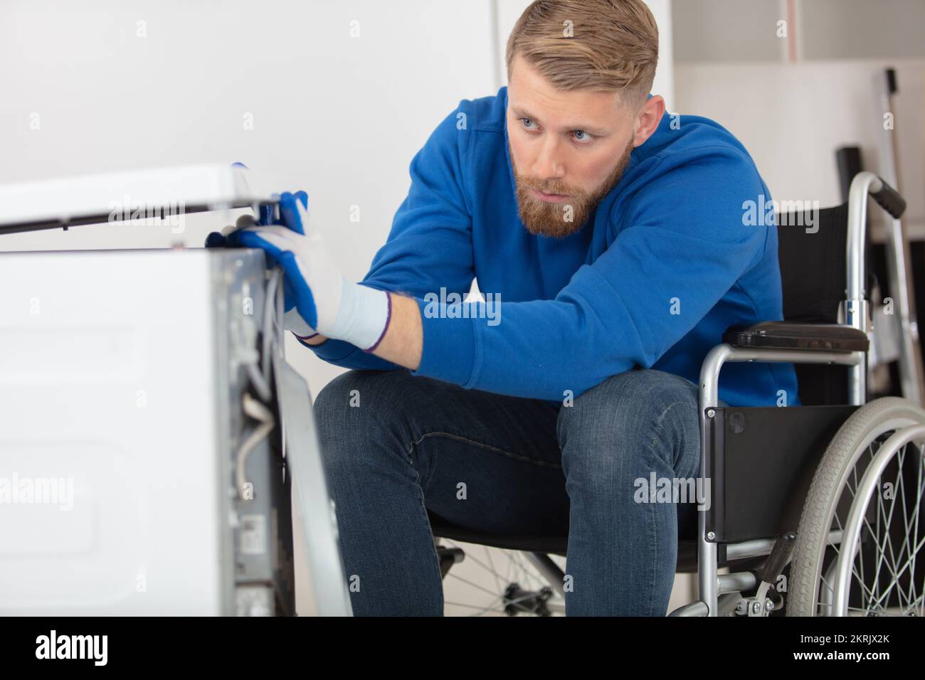 disabled man working as a repairman Stock Photo - Alamy