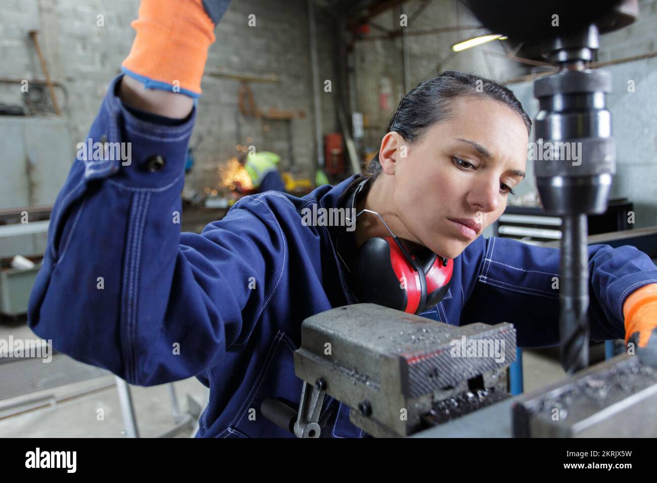 pretty employee milling at the factory Stock Photo - Alamy