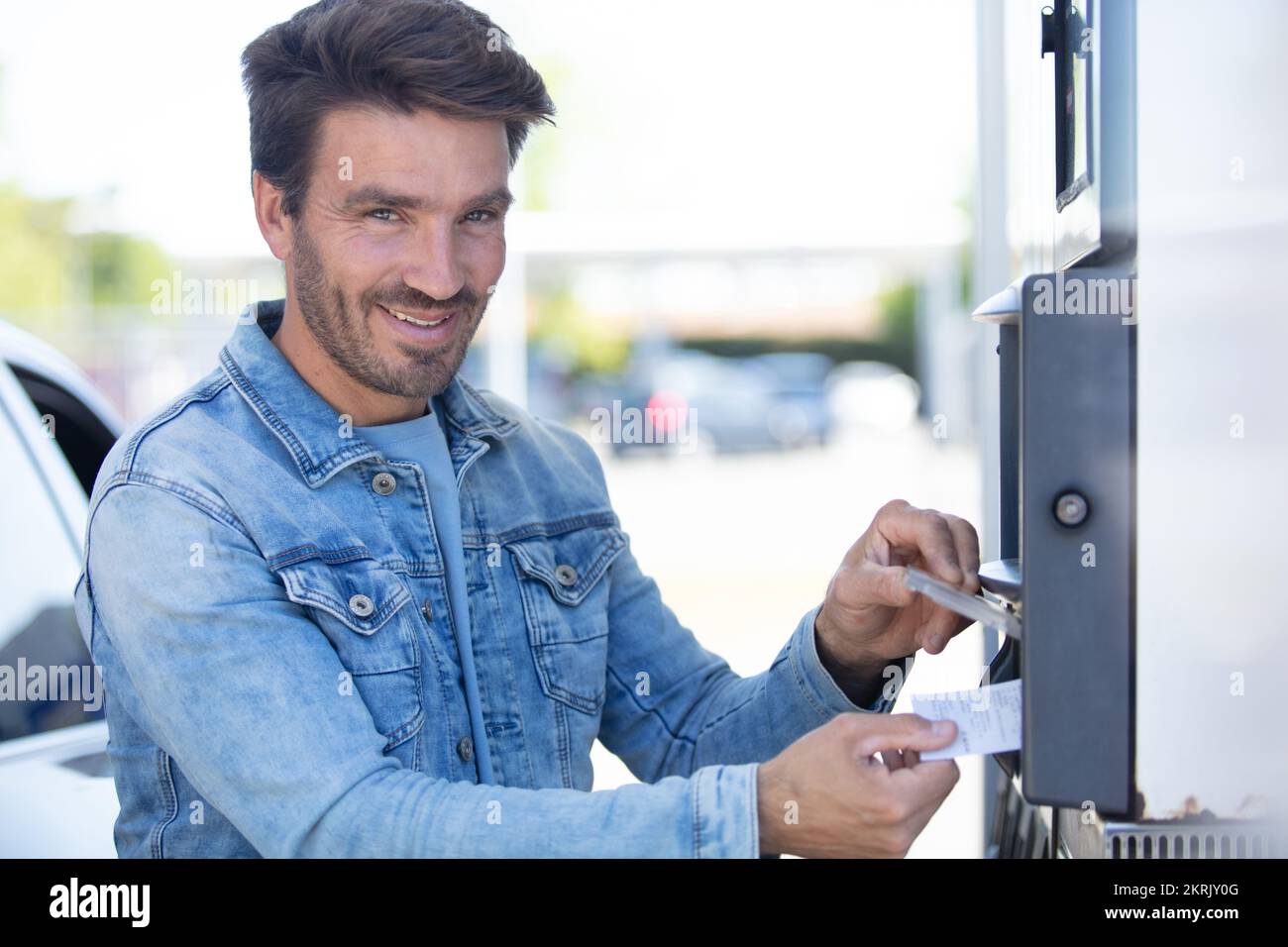 happy man taking ticket to pass control on parking area Stock Photo - Alamy
