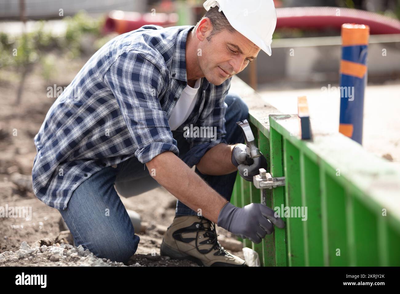 mature construction worker laying foundations Stock Photo - Alamy