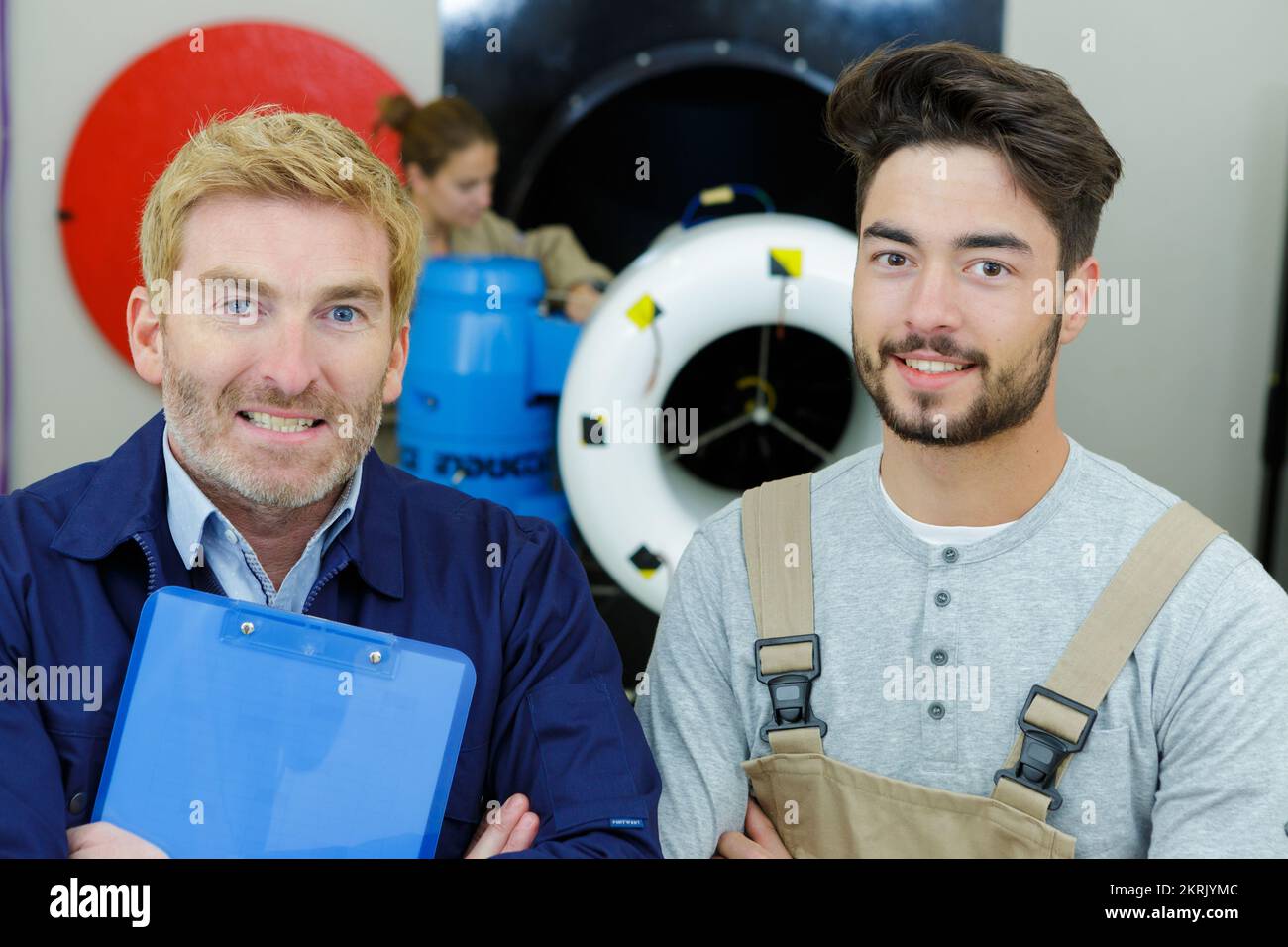 two men at work looking at camera Stock Photo - Alamy