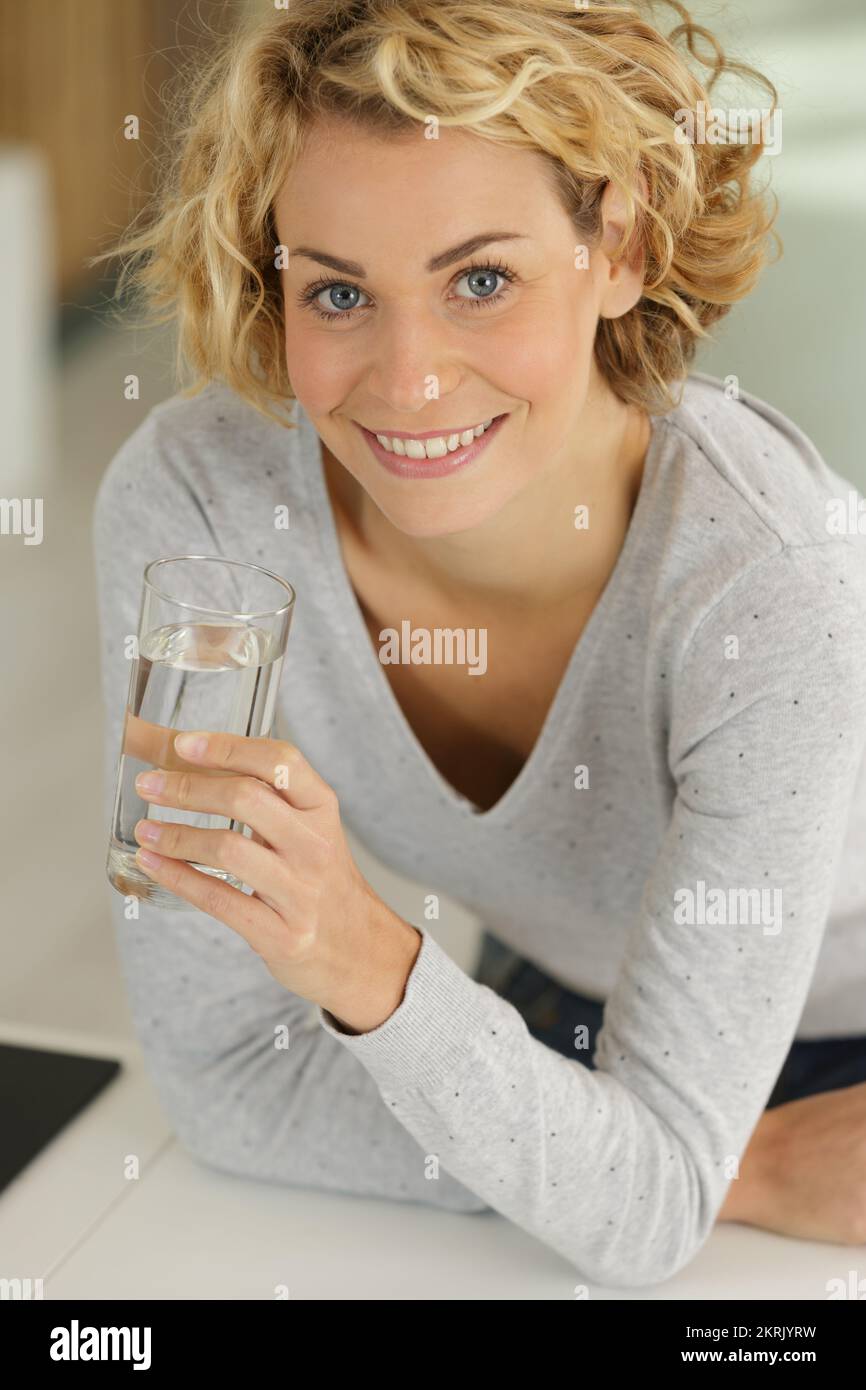 satisfied young woman drinking water Stock Photo - Alamy