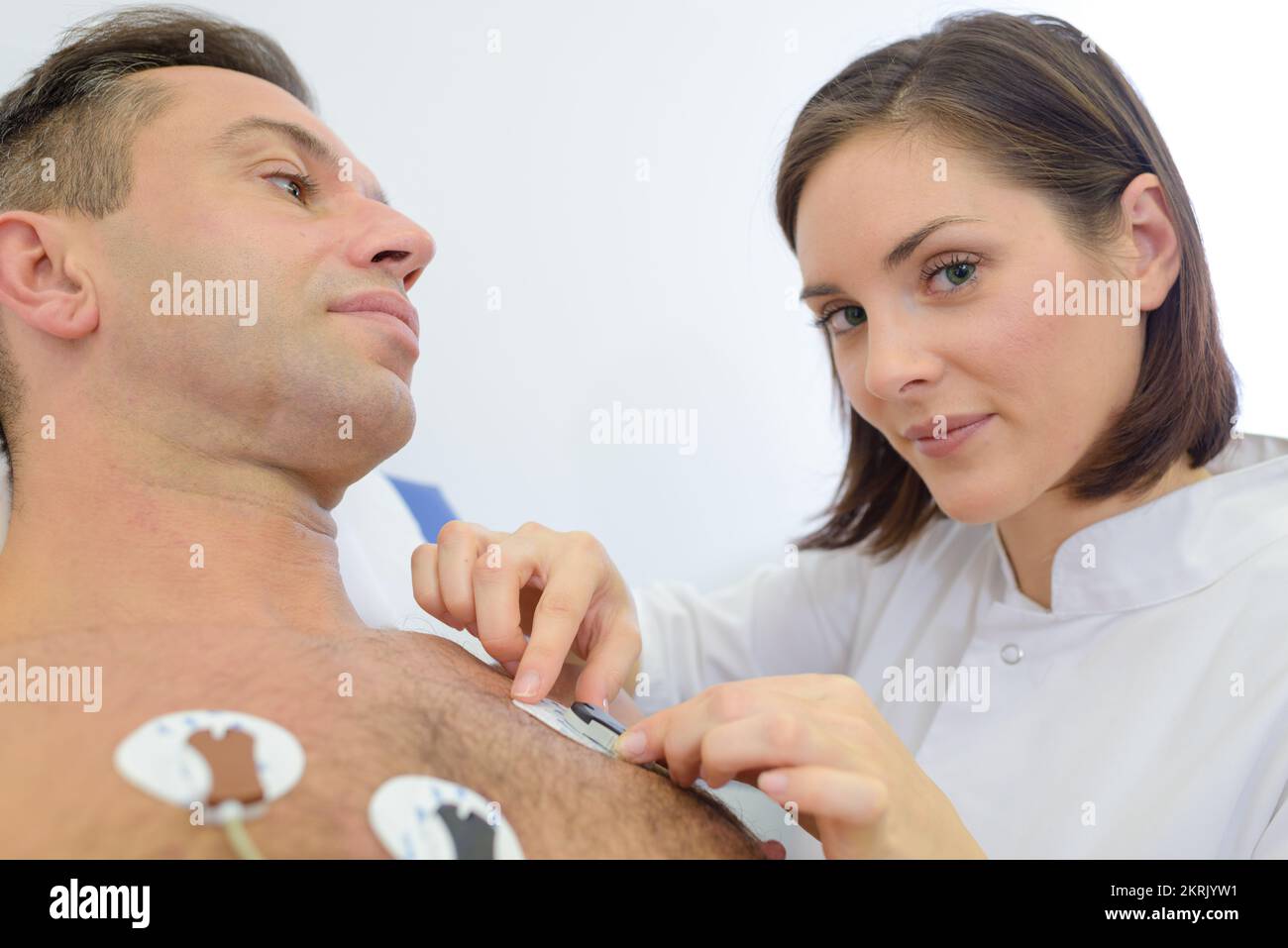 portrait of nurse putting of electrodes Stock Photo - Alamy
