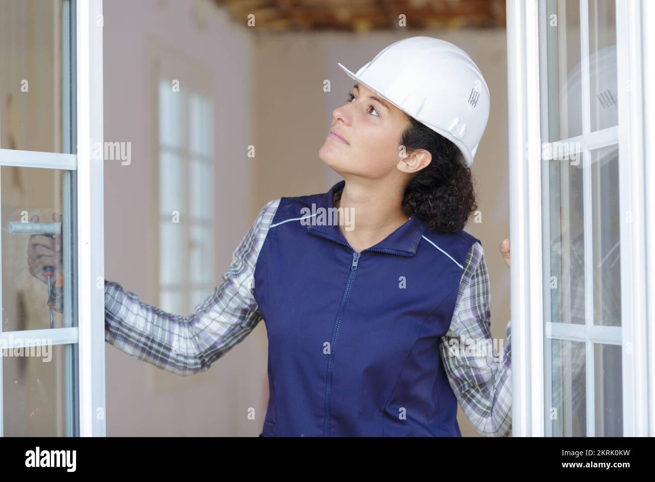 woman installing bay window in a new house construction site Stock ...