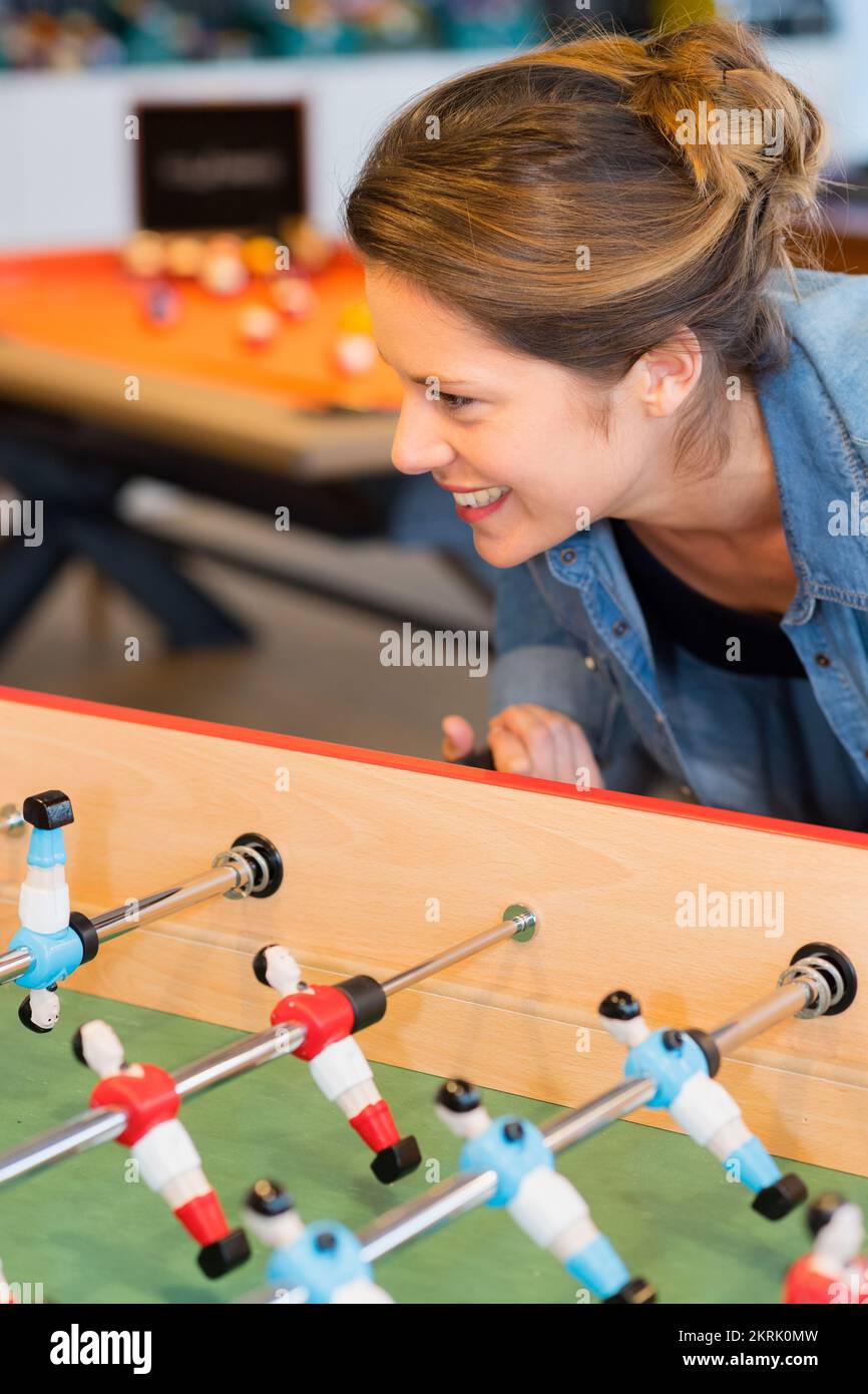 portrait of woman playing table football Stock Photo - Alamy