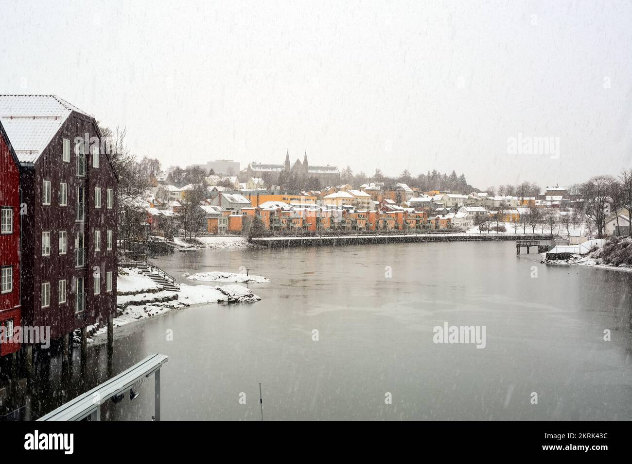 Snowfall in Norwegian city Trondheim, view of the river Nidelva and ...