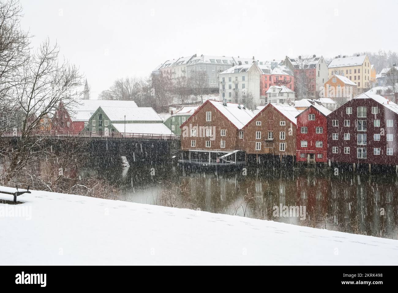 Snowfall in Norwegian city Trondheim, view of the river Nidelva and ...