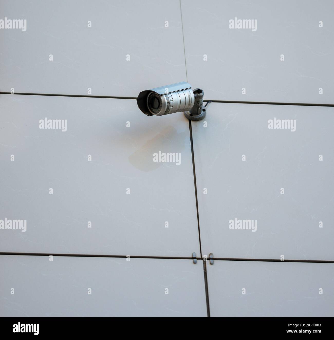 Surveillance camera on the wall of the building Stock Photo - Alamy