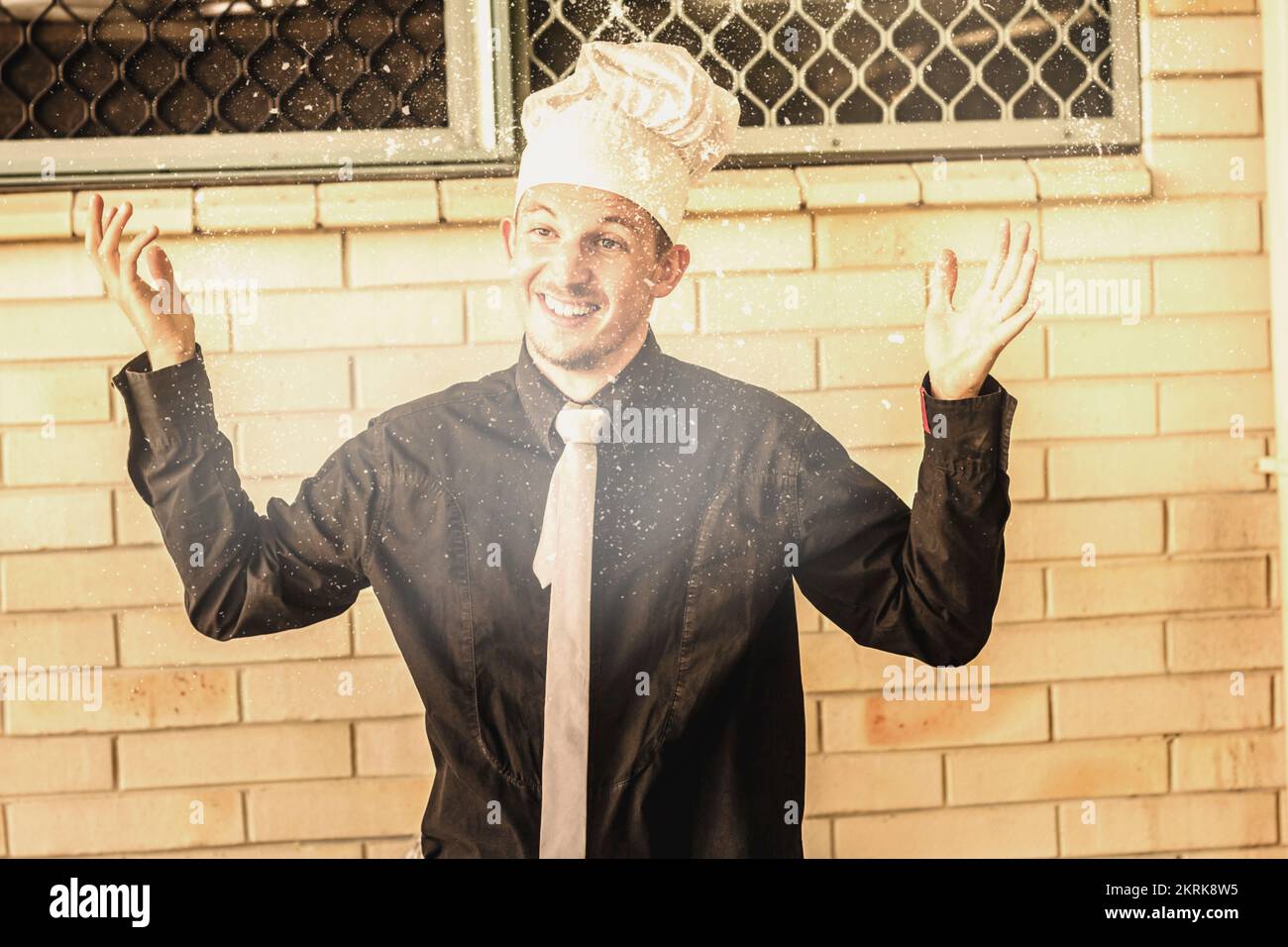 Funny portrait of a male cook waving hands in the air with puffs of ...