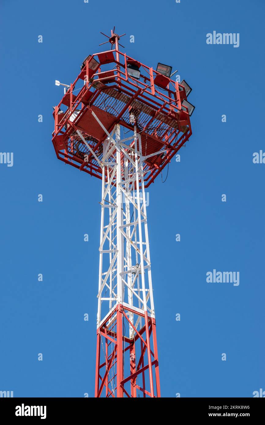 Security tower with spotlight over blue sky background Stock Photo - Alamy