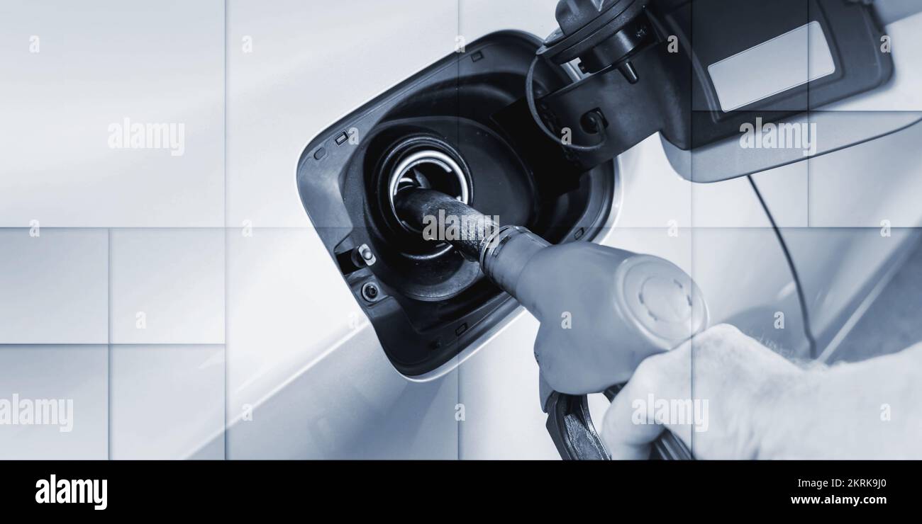 Hand holding yellow fuel pump nozzle and refilling car, geometric ...