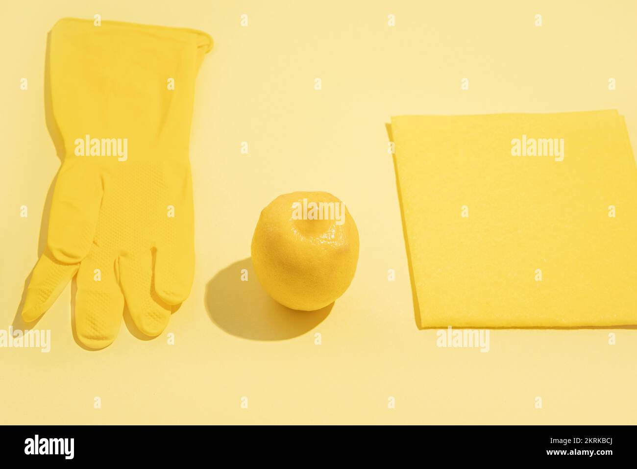 Cleaning and mopping supplies. Rubber glove, cloth rag, lemon. Yellow ...
