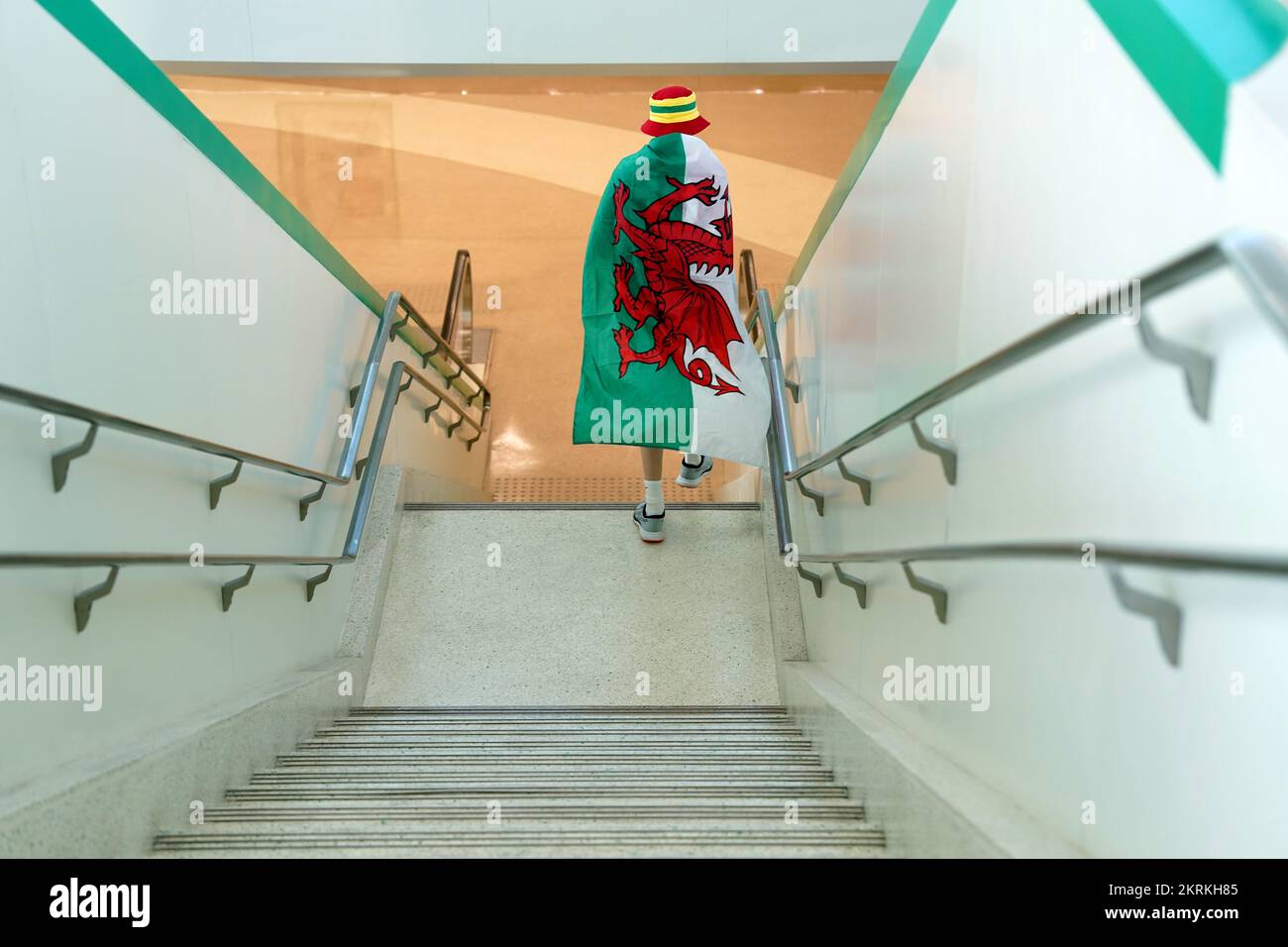 A lone Wales fan wearing a flag heads to a metro station on the day of ...
