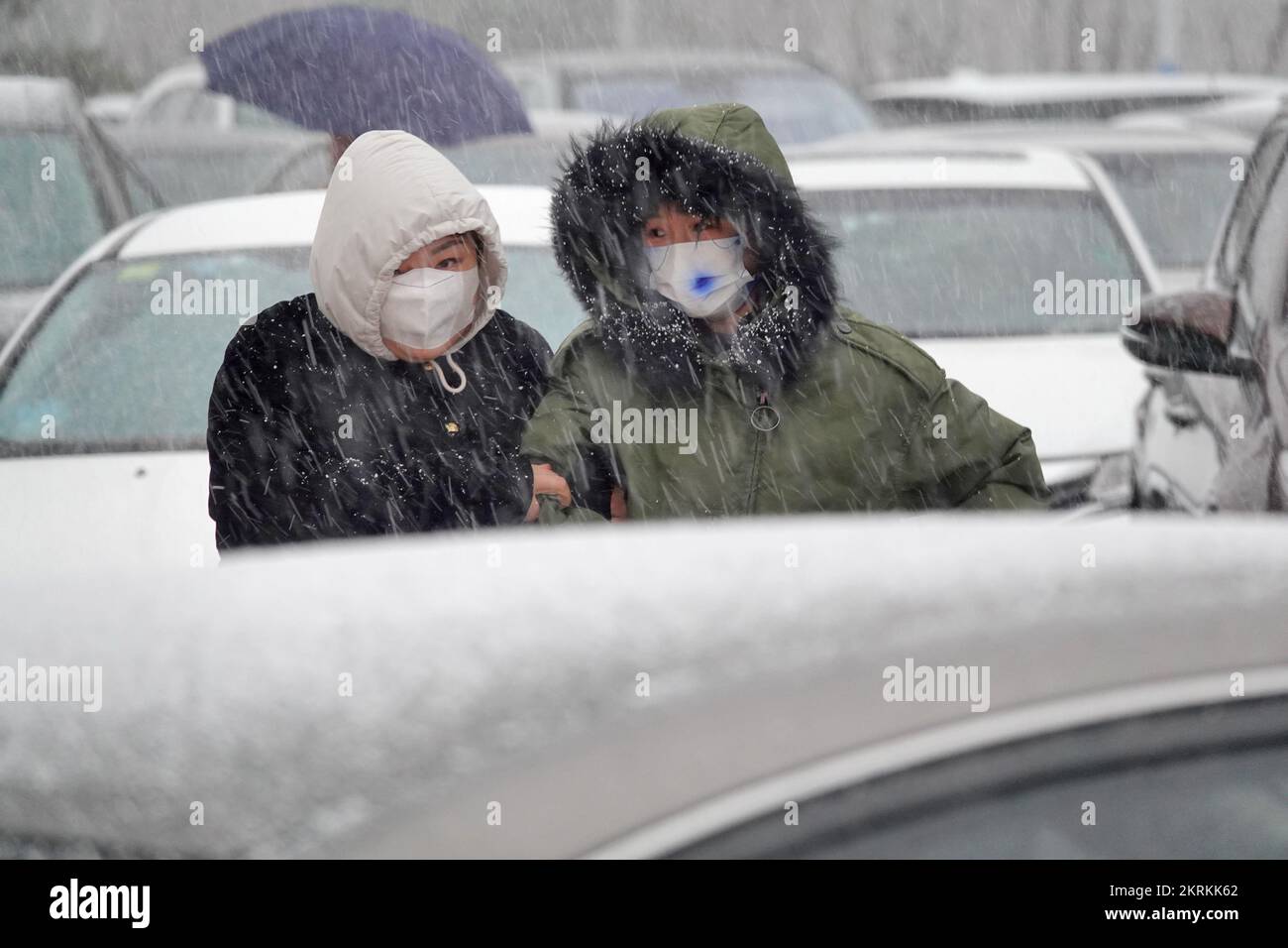 YANTAI, CHINA - NOVEMBER 29, 2022 - People brave snow on the street in ...