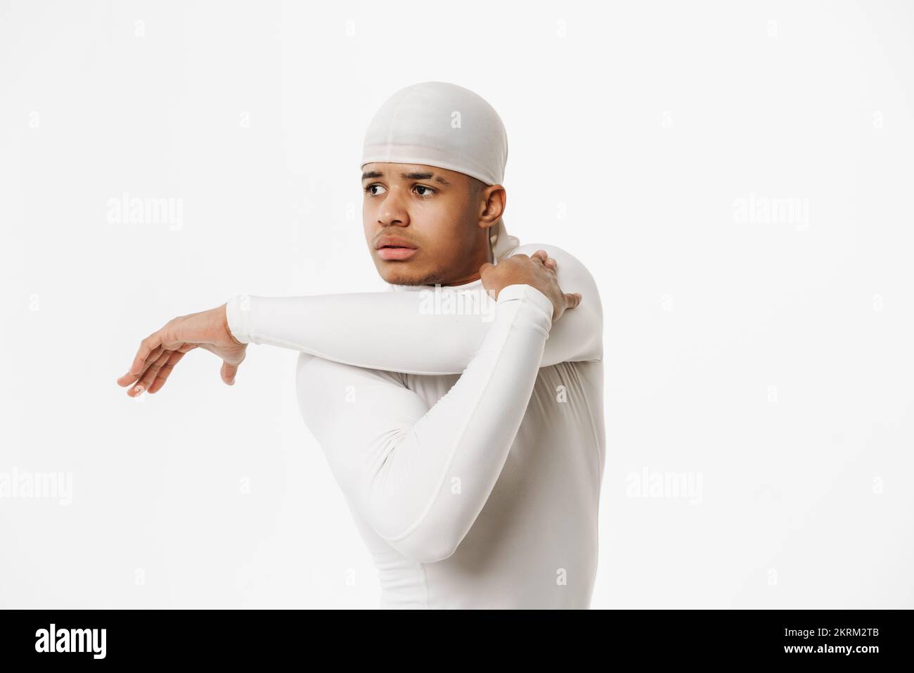 Young sportsman wearing bandana doing exercise while working out ...