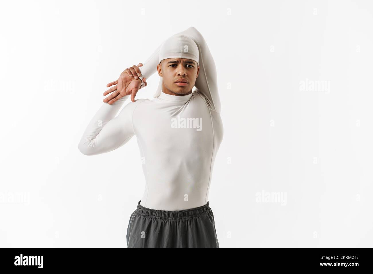 Young sportsman wearing bandana doing exercise while working out ...