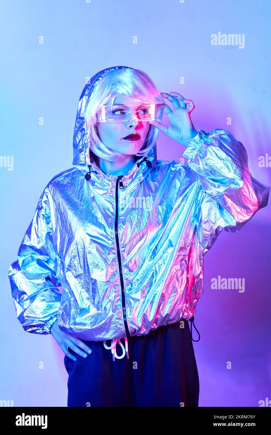 Young female in wig with smart augmented reality goggles with virtual ...