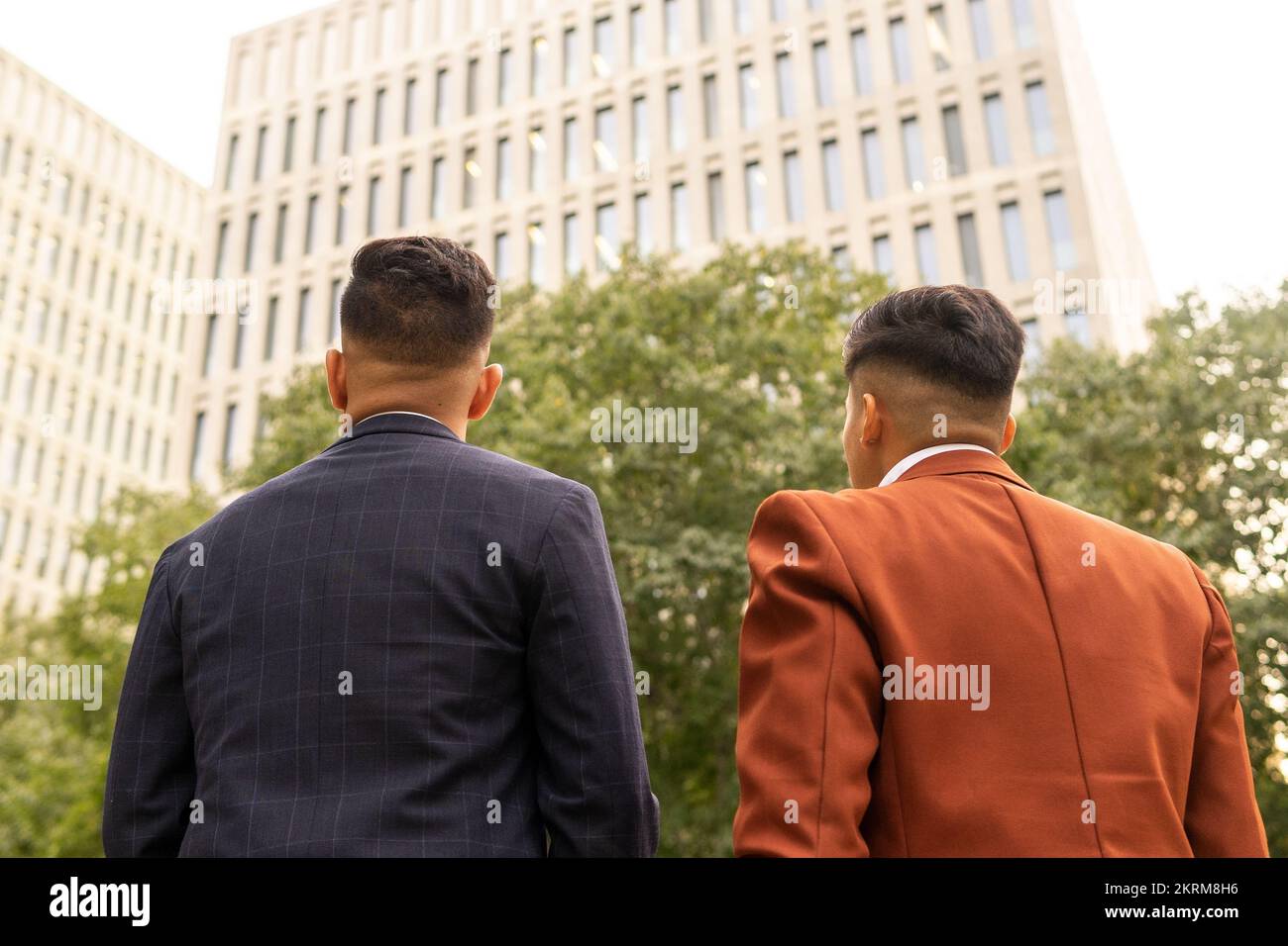 From bellow back view high angle of Hispanic men strolling on walkway ...