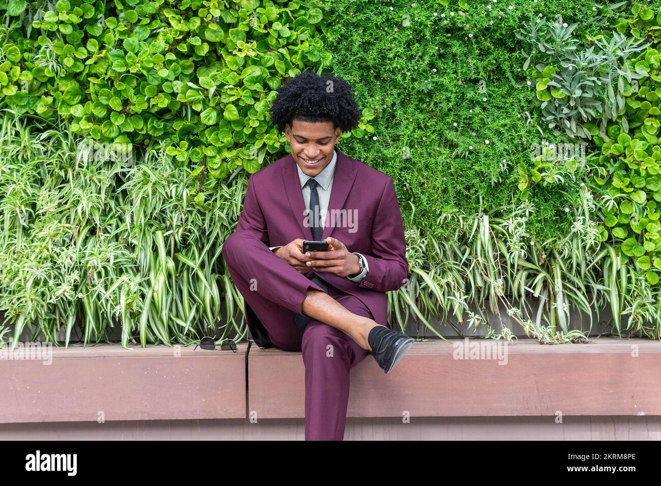 Cheerful young confident African American guy with dark curly hair in ...